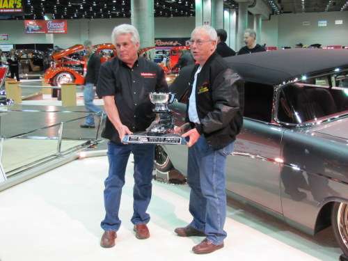 Owner and builder of '56 Ford holding the Ridler Award | Torque News
